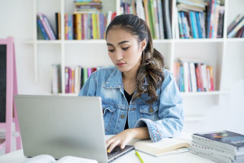 Female Student Typing on the Laptop while Studying Stock Photo - Image ...