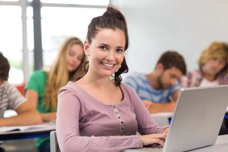 Female Student Using Laptop in Classroom Stock Photo - Image of college ...