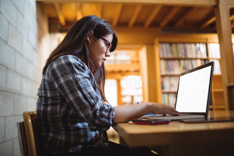 Female Student Using Laptop in Library Stock Image - Image of ...