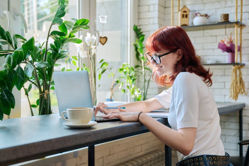Female Student Using Laptop, Sitting in Coffee Shop with Cup of Coffee ...