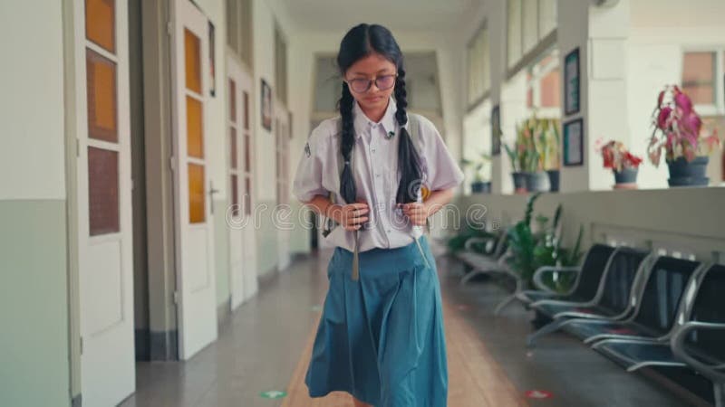 A Female Student Walking Alone in the School Hallway with a Sad ...