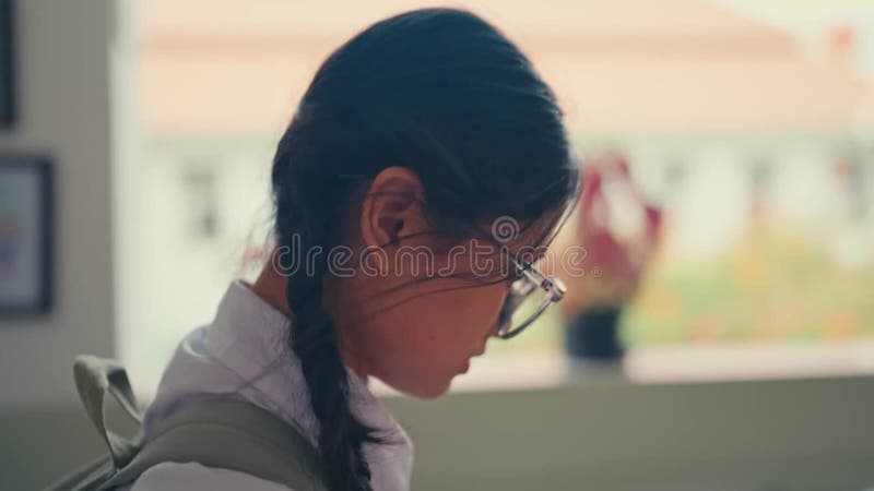 A Female Student Walking Alone in the School Hallway with a Sad ...