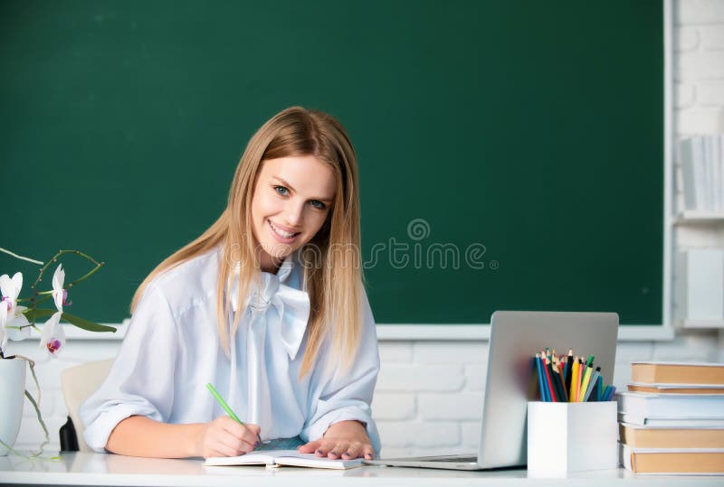 Female Student Writing on Notebook on Lesson Lecture in Classroom at ...