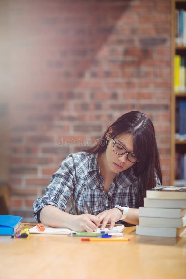 Female Student Writing Notes in Library Stock Photo - Image of adult ...