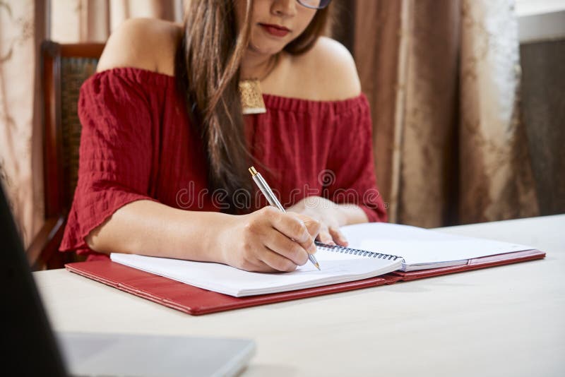 Female Student Writing in Textbook Stock Photo - Image of planning ...
