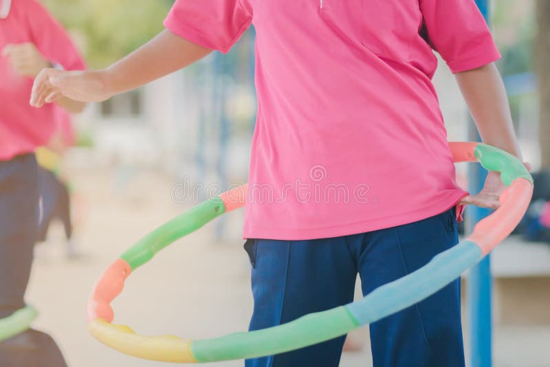 Female Students Doing Exercise with a Hula-hoop for a Good Healt Stock ...