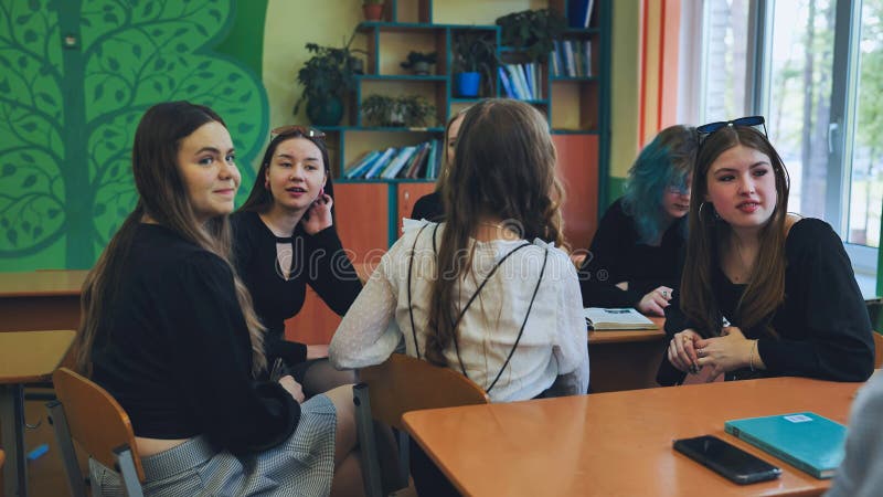 Female Students Having a Discussion during a Classroom Break between ...