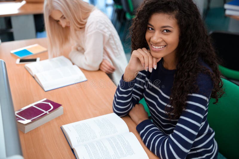 Female Students Reading Books in University Stock Photo - Image of ...