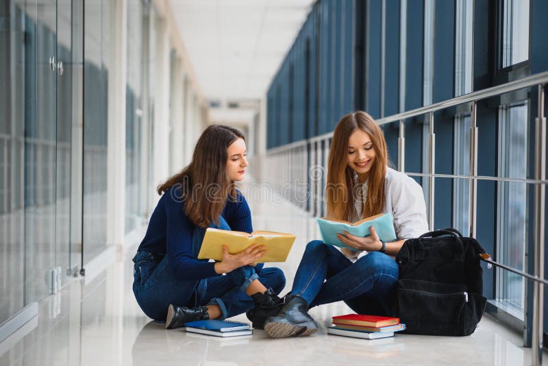 Female Students Sitting on the Floor and Reading Notes before Exam ...