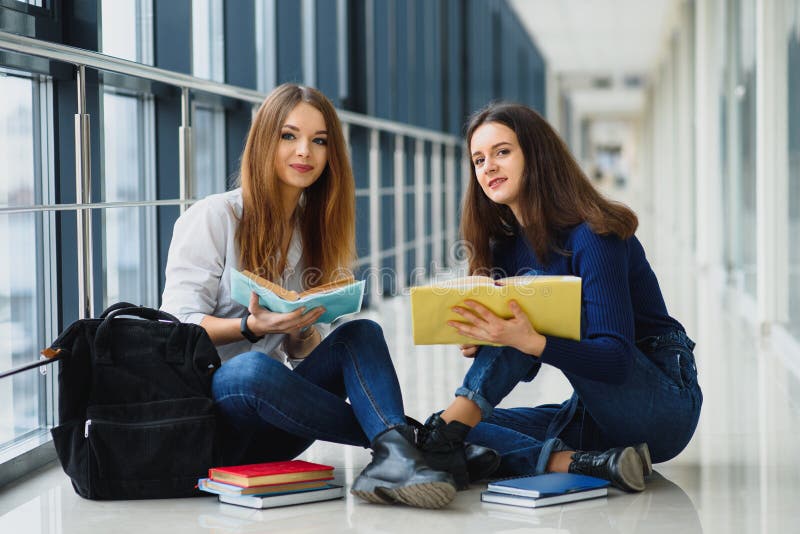 Female Students Sitting on the Floor and Reading Notes before Exam ...