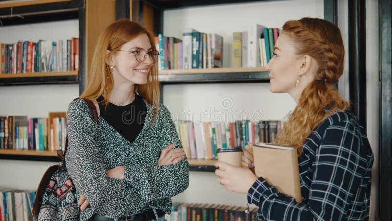 Female Students Talk in the Library about Books and Classes. Lots of ...