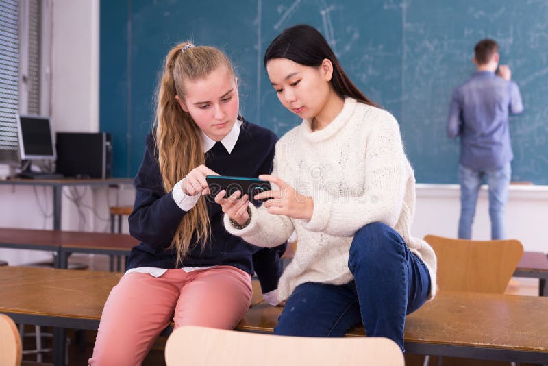 Female Students Talking and Using Smartphone during Break Stock Image ...