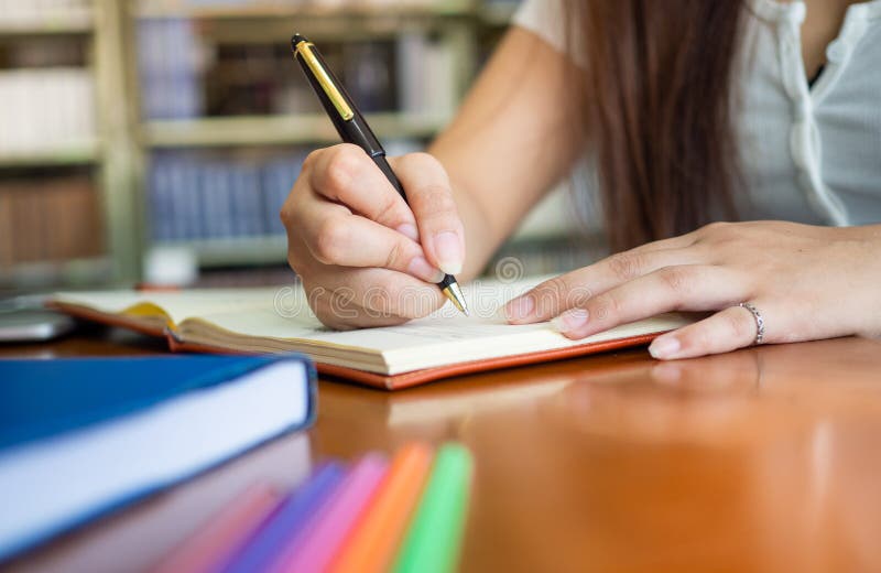 Female Students Writing Books Inside the Library. Do Homework and ...