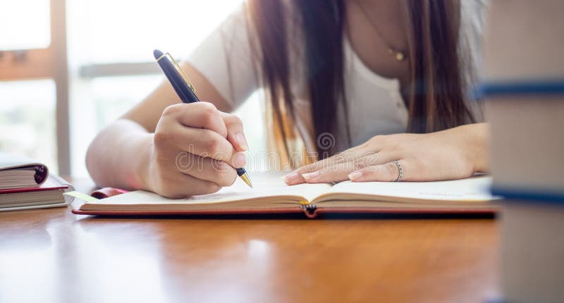 Female Students Writing and Reading in the Library Stock Photo - Image ...