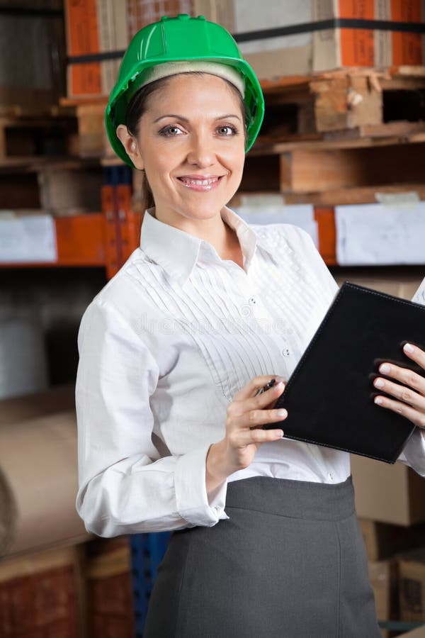 Female Supervisor with Book at Warehouse Stock Image - Image of adult ...