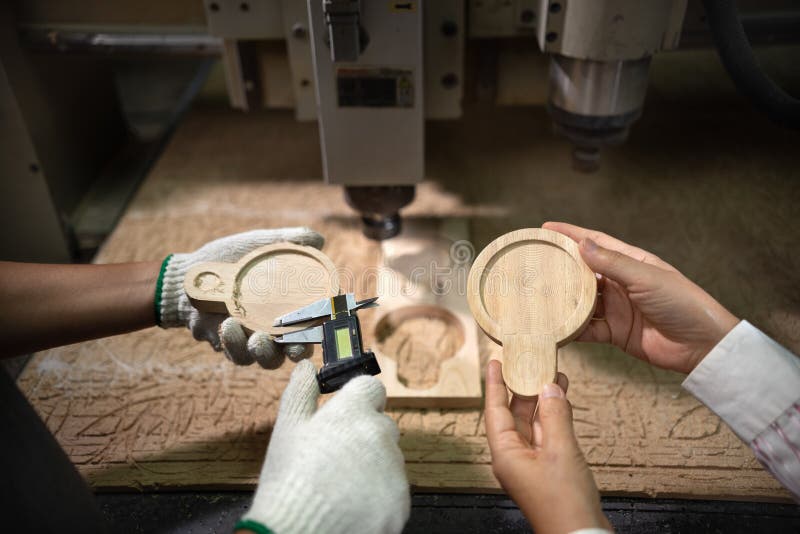 Female Supervisor and CNC Machine Operator Measuring Cut Out Product ...