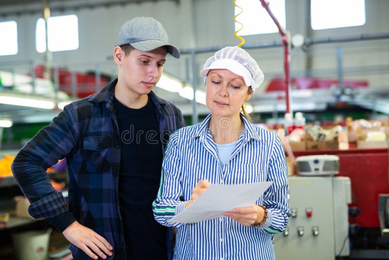 Female Supervisor Talking To Young Foreman of Citrus Sorting Factory ...