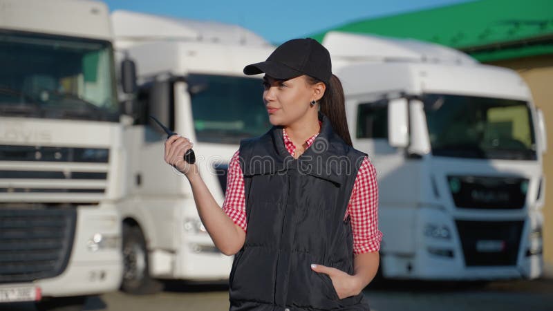 Female Supervisor Directing Truck Loading with Walkie-talkie Stock ...