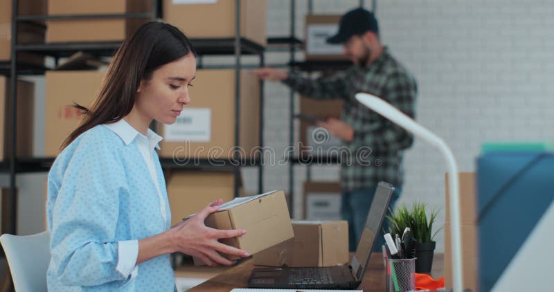 A Female Support Service Manager Checks the Order Number on the Parcel ...