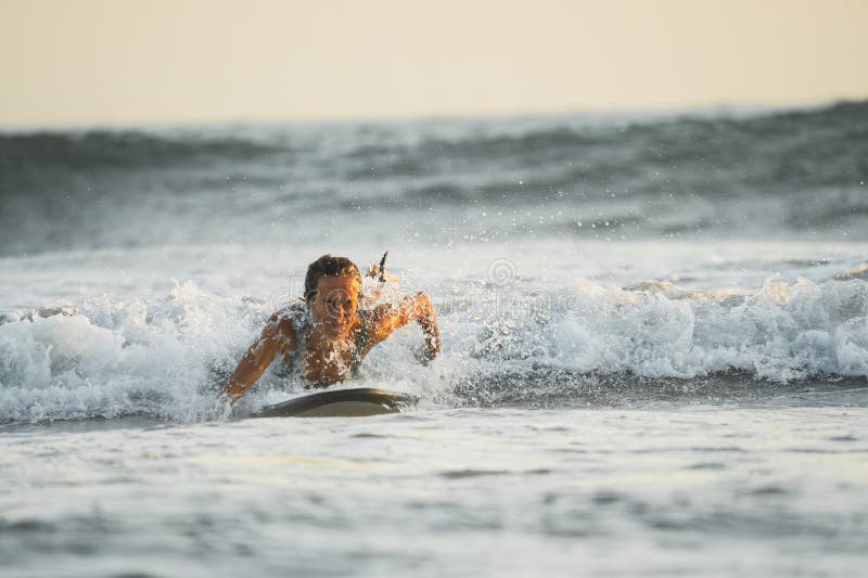 Female Surfer Swimming Upstream To Catch a Wave Stock Photo - Image of ...