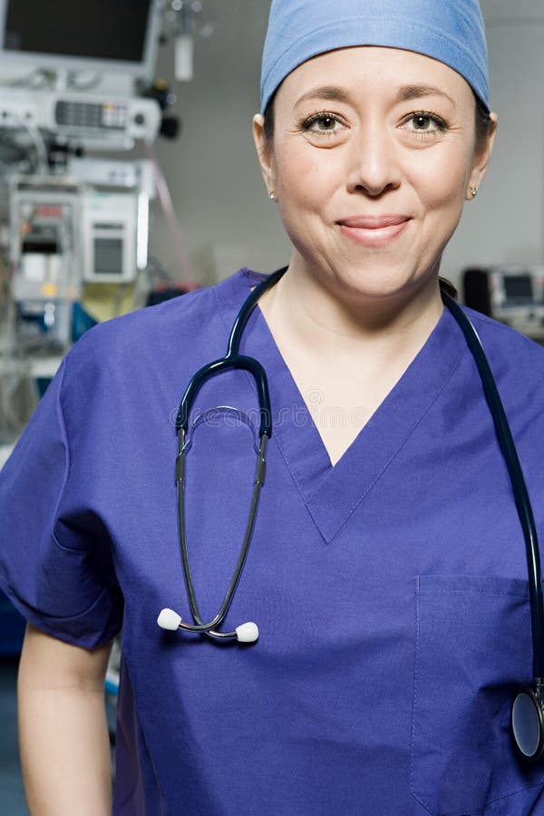 Female Surgeon Putting on Gloves in the Operating Room, Midsection ...