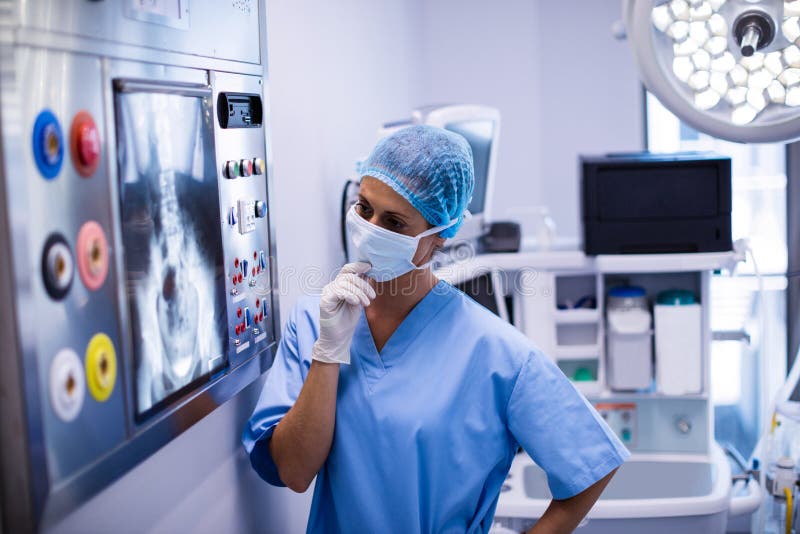 Female Surgeon Reading X-ray Stock Photo - Image of emergency ...