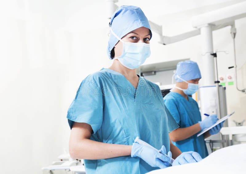 Female Surgeon Working in the Operating Room, Looking at Camera Stock ...