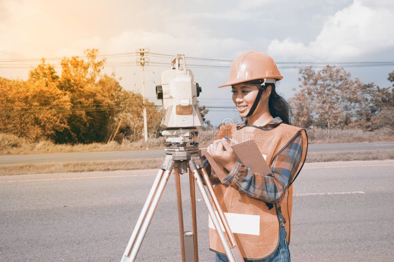 Female Surveyor or Engineer Making Measure on the Highway. Stock Photo ...