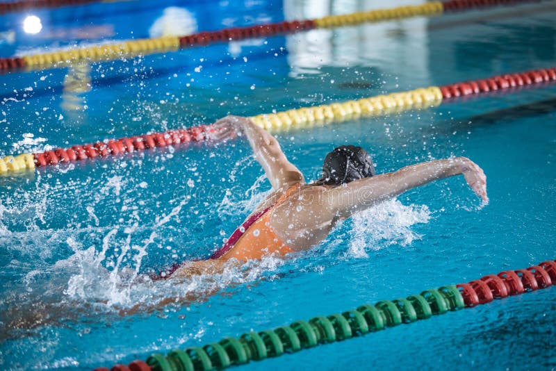 Female Swimmer Moving through the Water Performs a Butterfly Stroke ...
