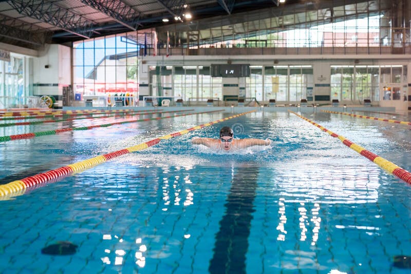 Female Swimmer Moving through the Water Performs a Butterfly Stroke ...