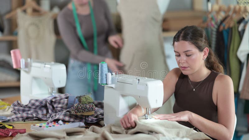 Two Female Tailors Work in a Sewing Workshop. Fashion Designer Checks a ...