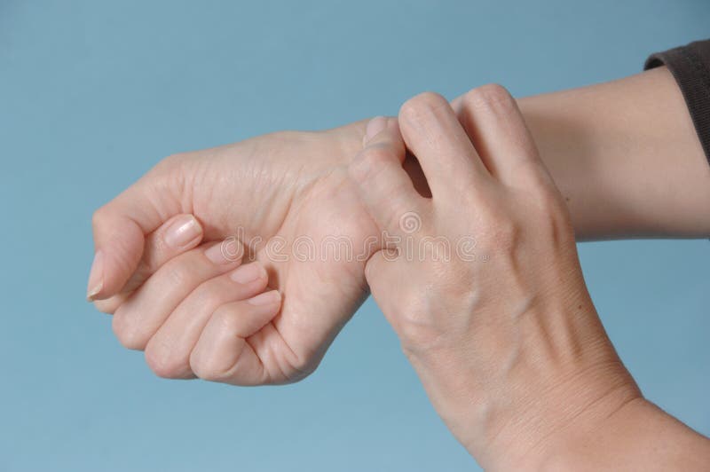Female Taking Her Own Pulse Against Blue Stock Photo - Image of ...