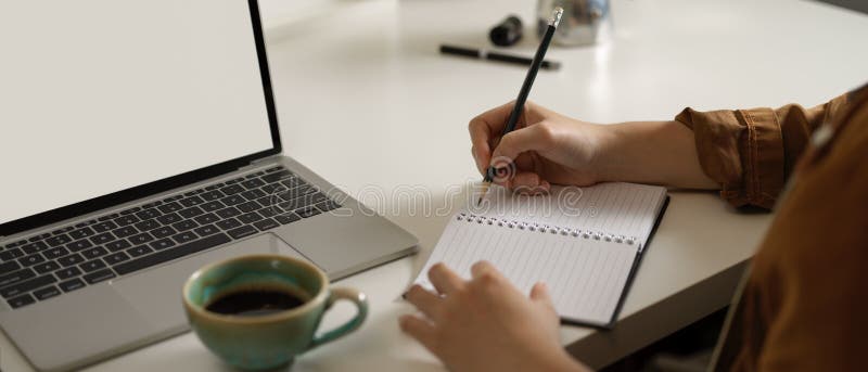 Female Taking Note on Blank Notebook while Working with Mock Up Laptop ...