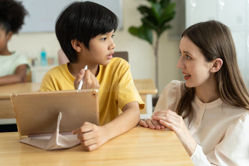 Teacher Guiding Student with Digital Learning in Diverse Classroom ...