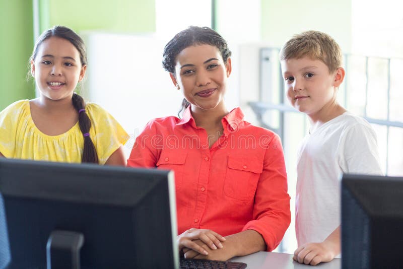 Female Teacher with Children in Computer Class Stock Photo - Image of ...