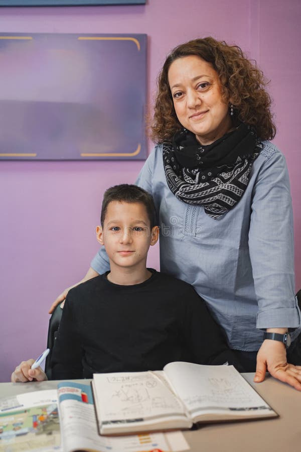Female Teacher with Elementary Student at Language School Class Stock ...