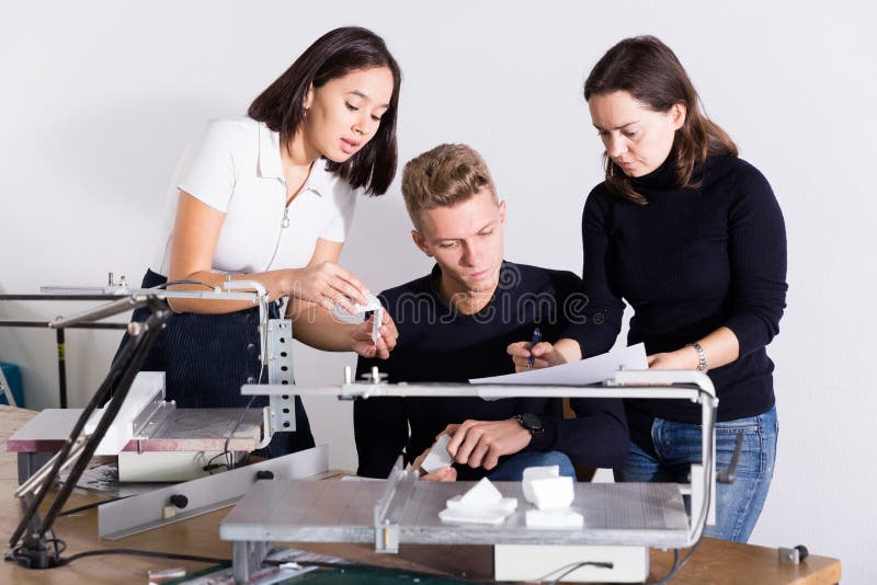Female Teacher Explaining Architectural Modeling To Students Stock ...