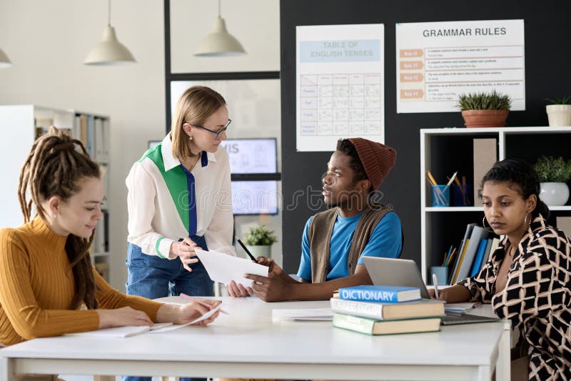 Female Teacher Helping Student during Class Stock Image - Image of ...