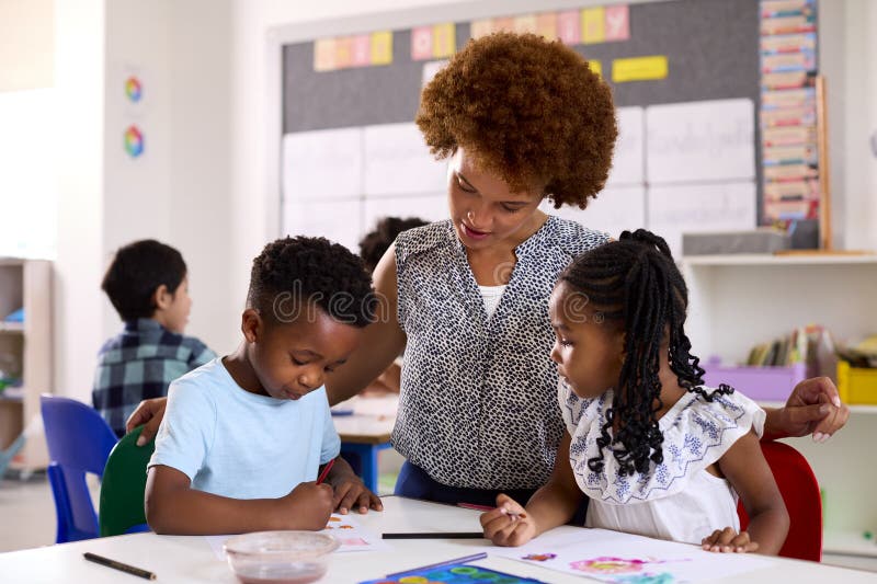 Female Teacher Reads To Multi-Cultural Elementary School Pupils Sitting ...