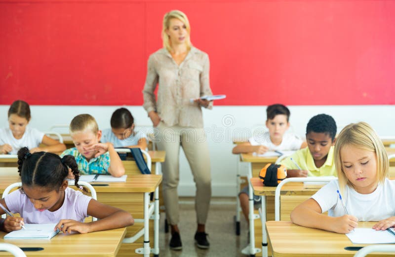 Teacher and Pupils Working in Classroom at Elementary School Stock ... Teacher and Pupils Working in Classroom at Elementary School Stock ...