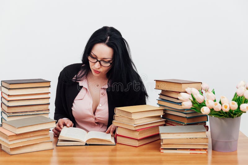Female Teacher at a Table with Books for Teaching Stock Photo - Image ...