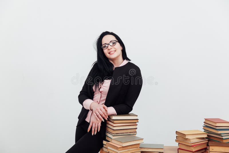 Female Teacher at a Table with Books in the University Library Stock ...