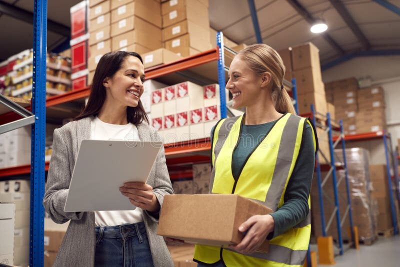 Female Team Leader with Clipboard in Warehouse Training Intern Standing ...