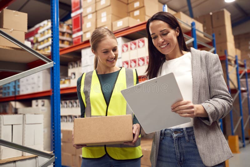 Female Team Leader with Clipboard in Warehouse Training Intern Standing ...
