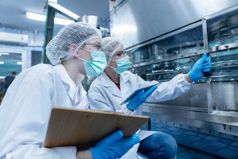Female Team Worker Using Tablet Checking Quality Drinking Water before ...