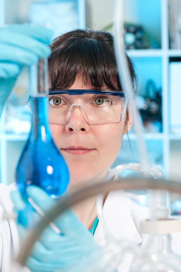 Technician with a Measuring Glass Stock Photo - Image of liquid ...