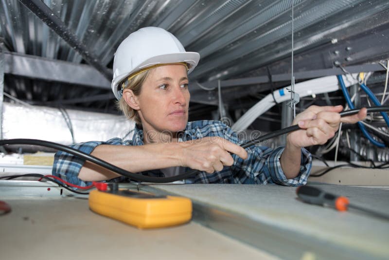 Female Technician Checking Air Conditioning in Ceiling Stock Photo ...