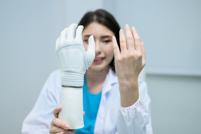 Female Technician Checking and Controlling Artificial Prosthetic Hand ...