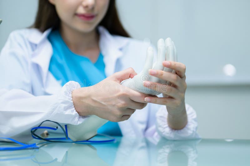 Female Technician Checking and Controlling Artificial Prosthetic Hand ...