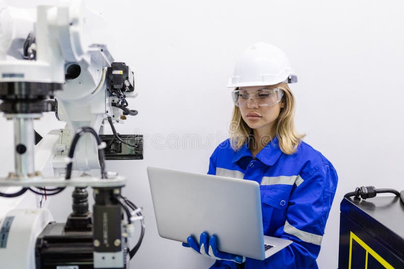 Female Technician Engineer Using Laptop Checking Automation Robotics At